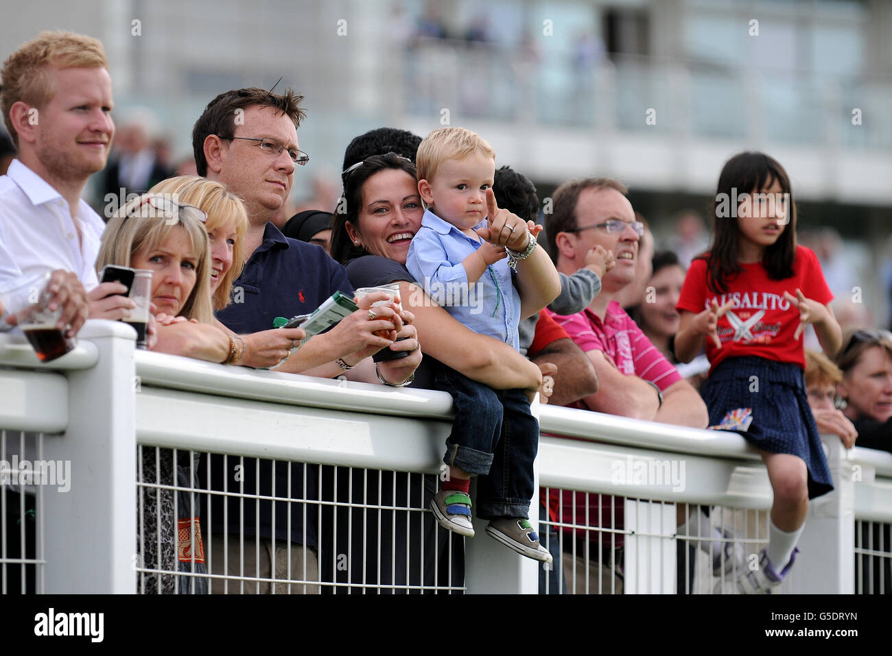 Horse Racing - Family Day - Sandown Park. Racegoers watch the action at ...