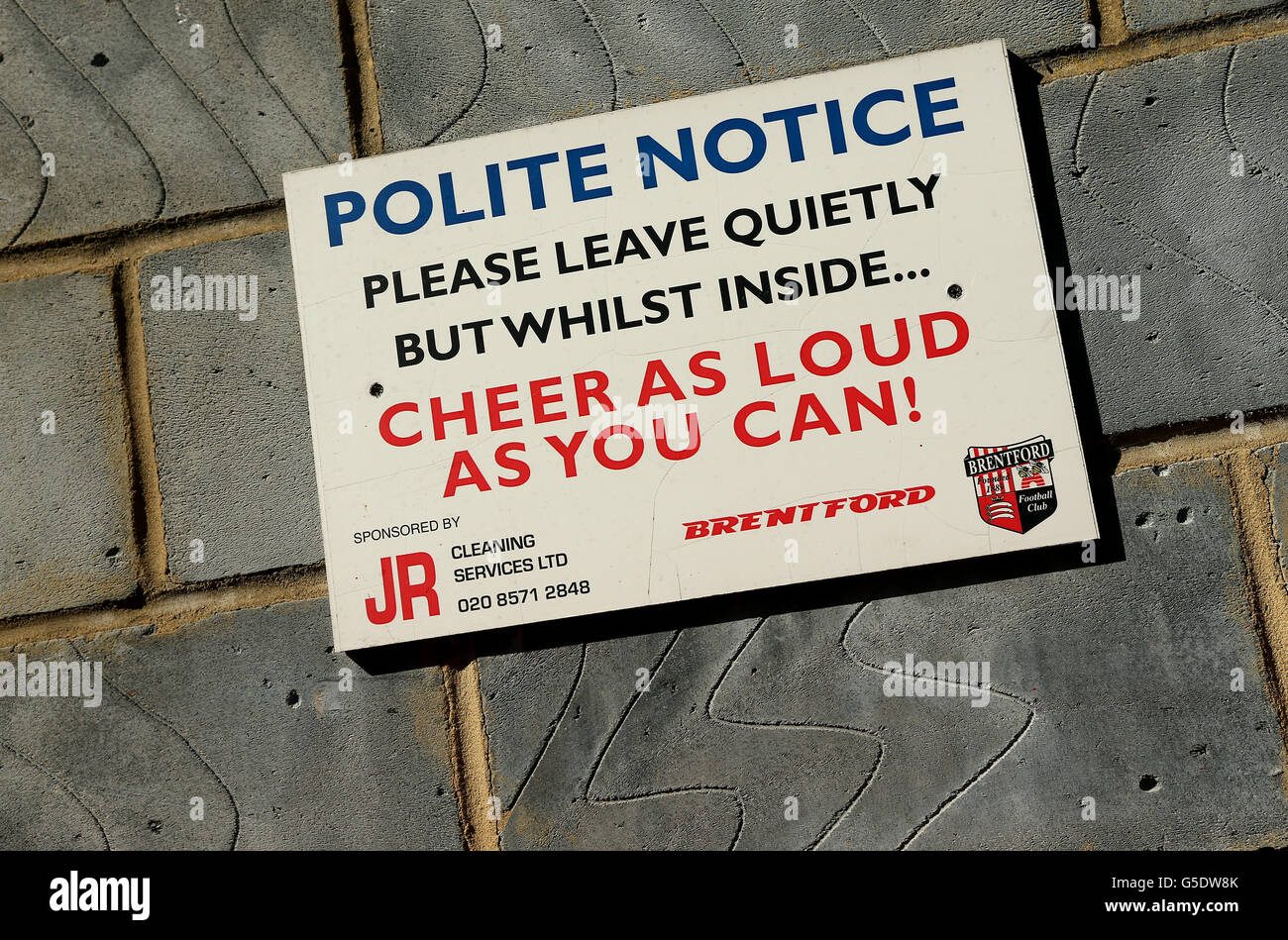 A sign encourages fans to cheer on their team at Griffin Park Stadium ...