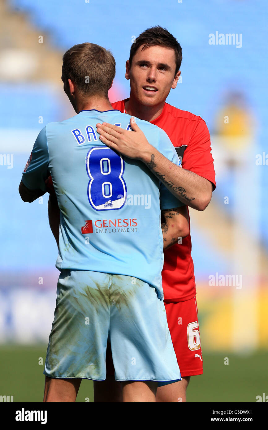 Stevenage's Greg Tansey (r) embraces Coventry City's Carl Baker at the ...