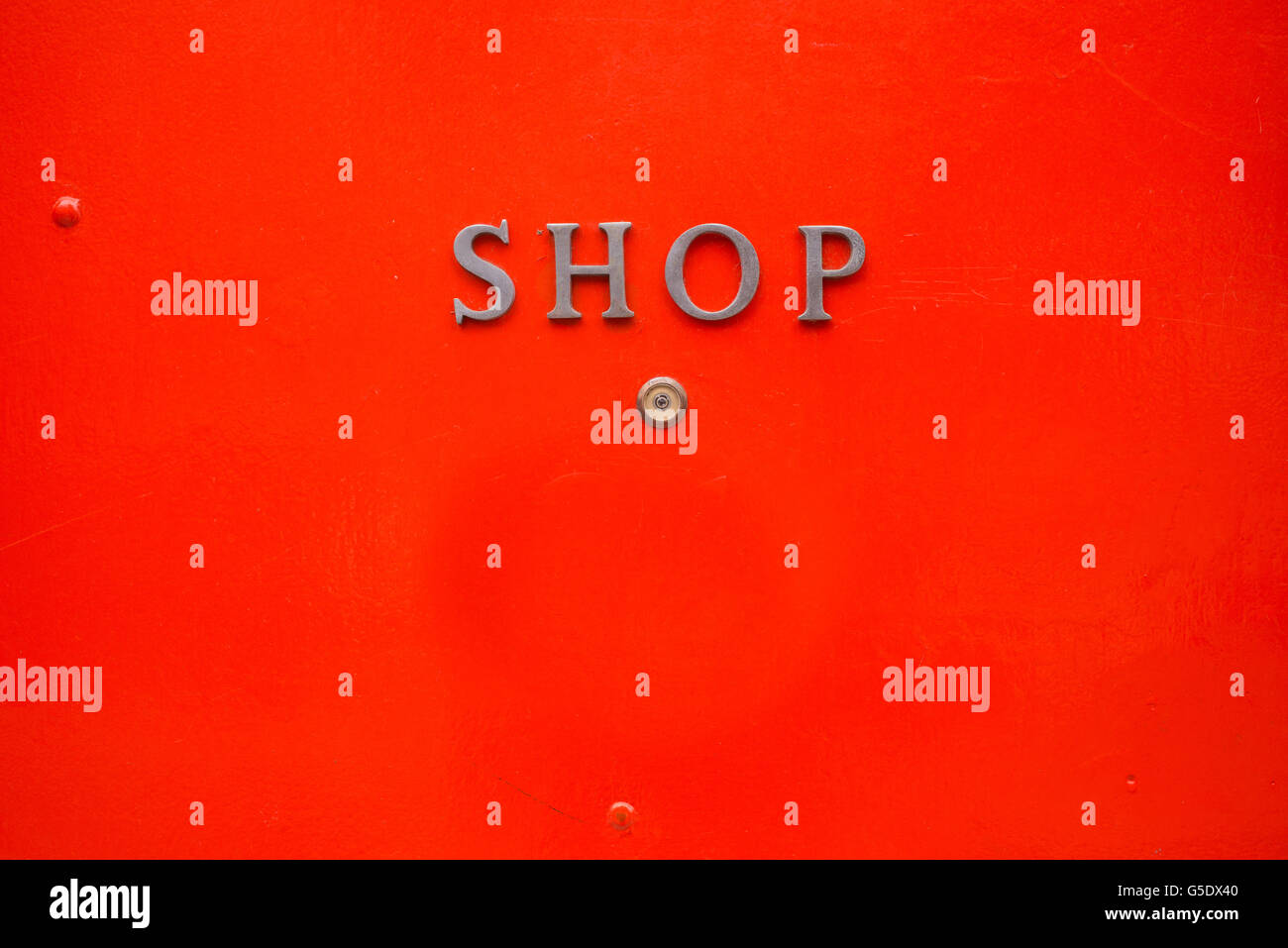 Shop written in metal letters on a bright red door background Stock ...