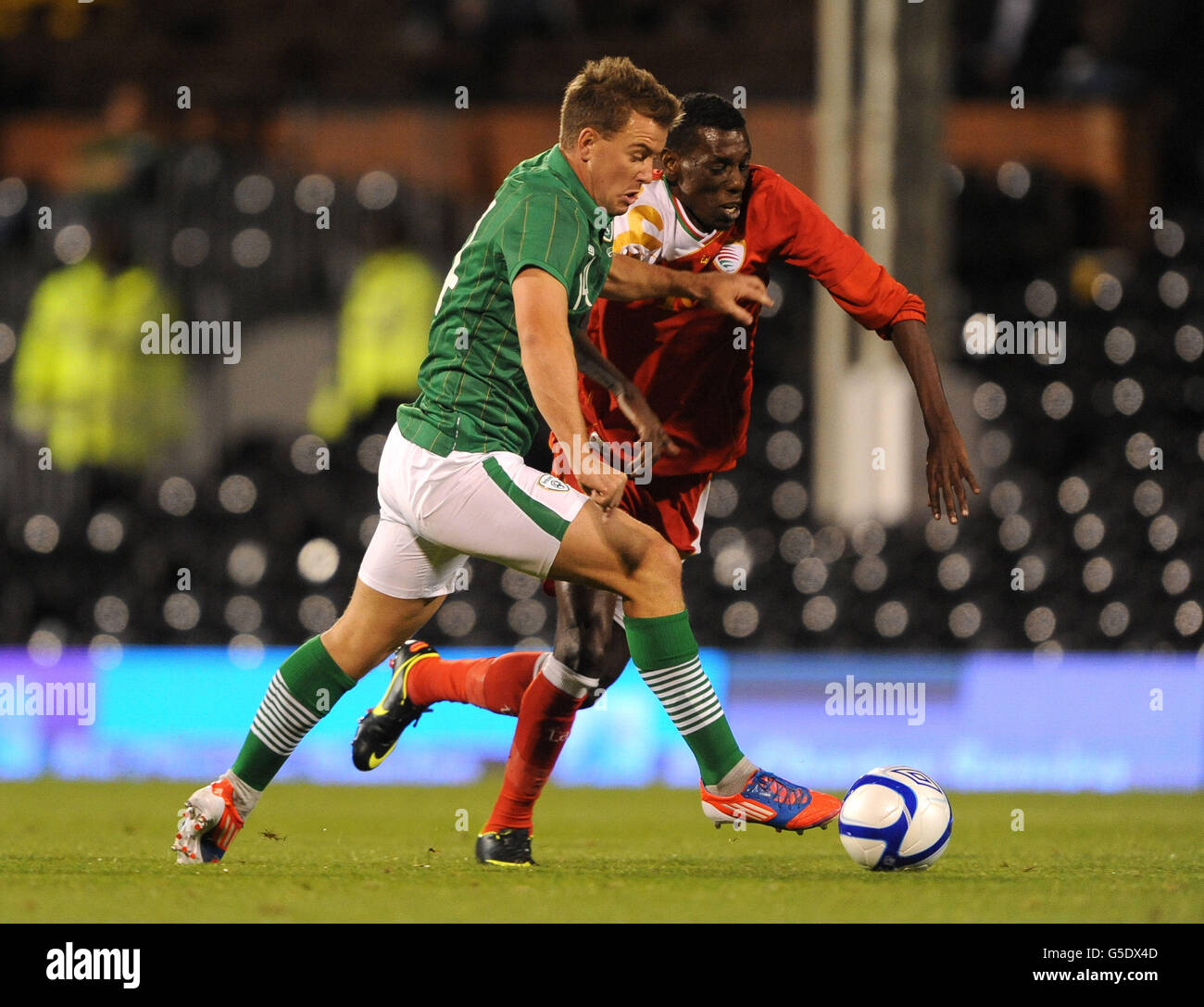 Republic of Ireland's Simon Cox (left) and Oman's Fawzi Basheer (right ...