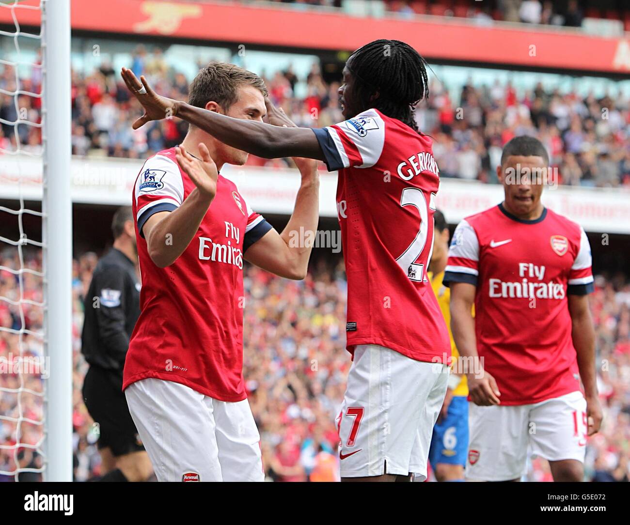 Arsenal's Gervinho (centre) celebrates with his team-mate Aaron Ramsey ...