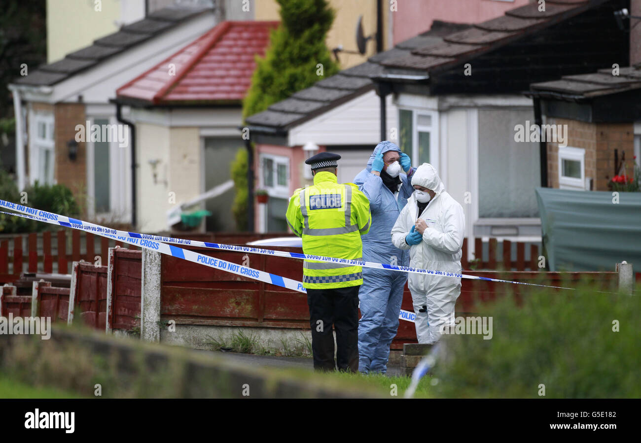 Police forensic officers search the scene of a shooting in Hattersley ...
