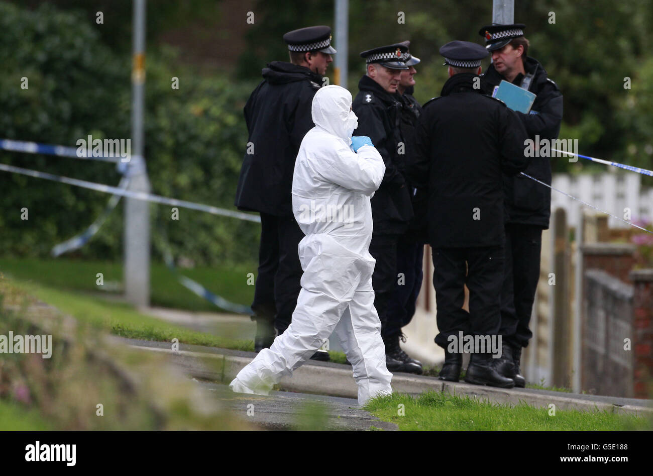 Police forensic officers search the scene of a shooting in Hattersley ...