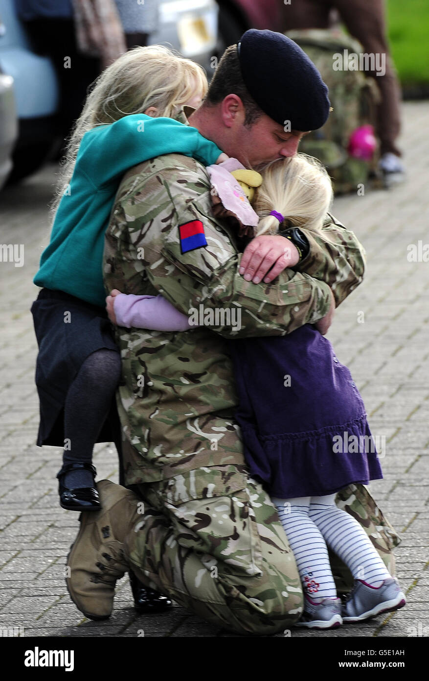 WO2 Simon Bell kisses goodbye to his daughters Catherine (left) and ...