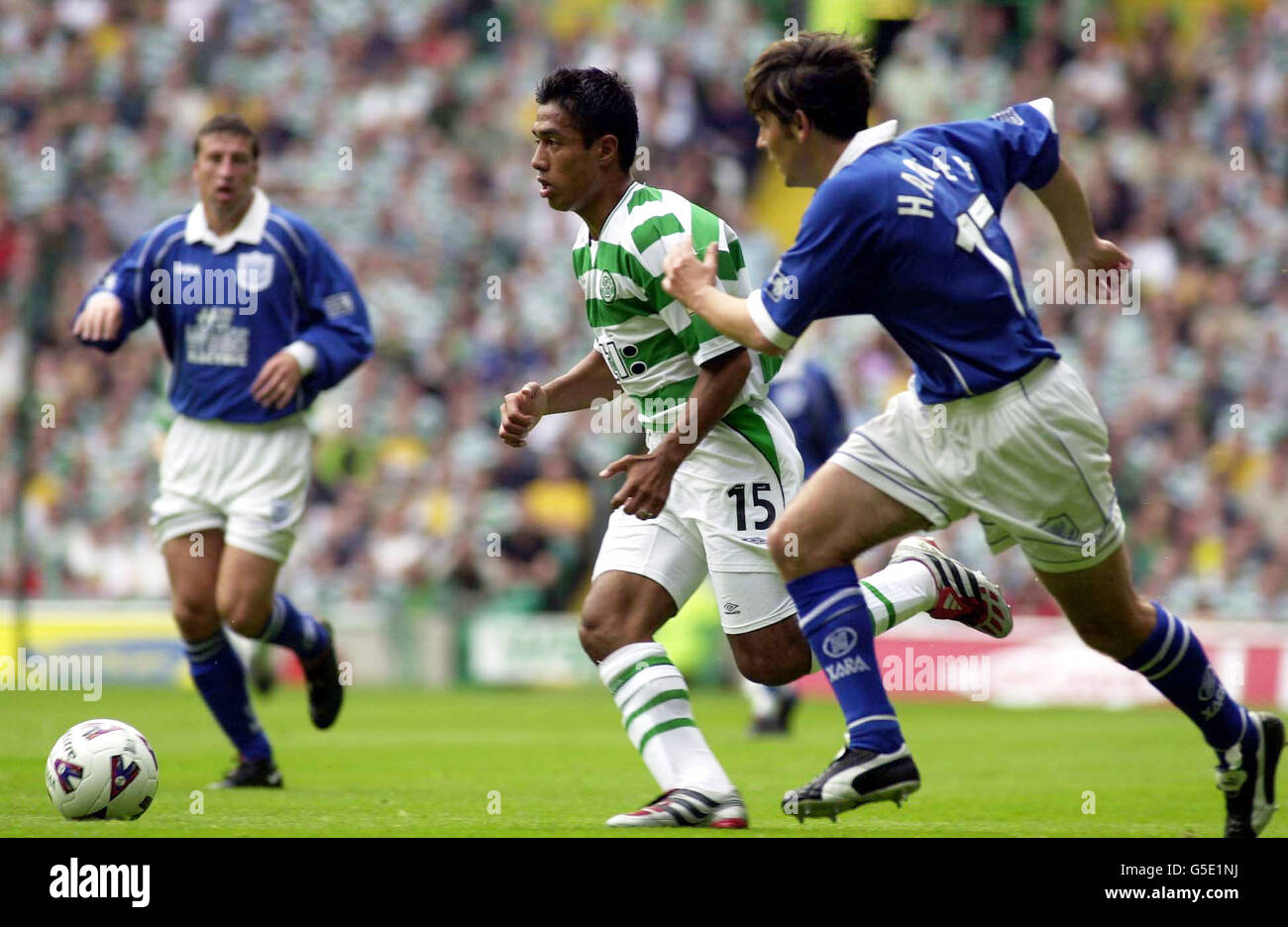 Celtic's Bobby Petta (centre) gets past St Johnstone's Paul Hartly ...