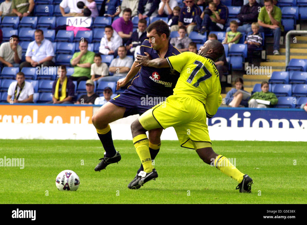 Wimbledon's first goal scorer Neil Shipperley (L) takes the ball from ...
