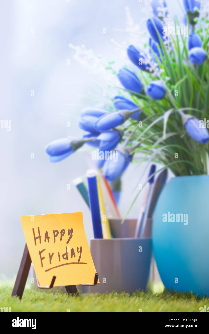Adhesive note with Happy Friday text at green office Stock Photo - Alamy