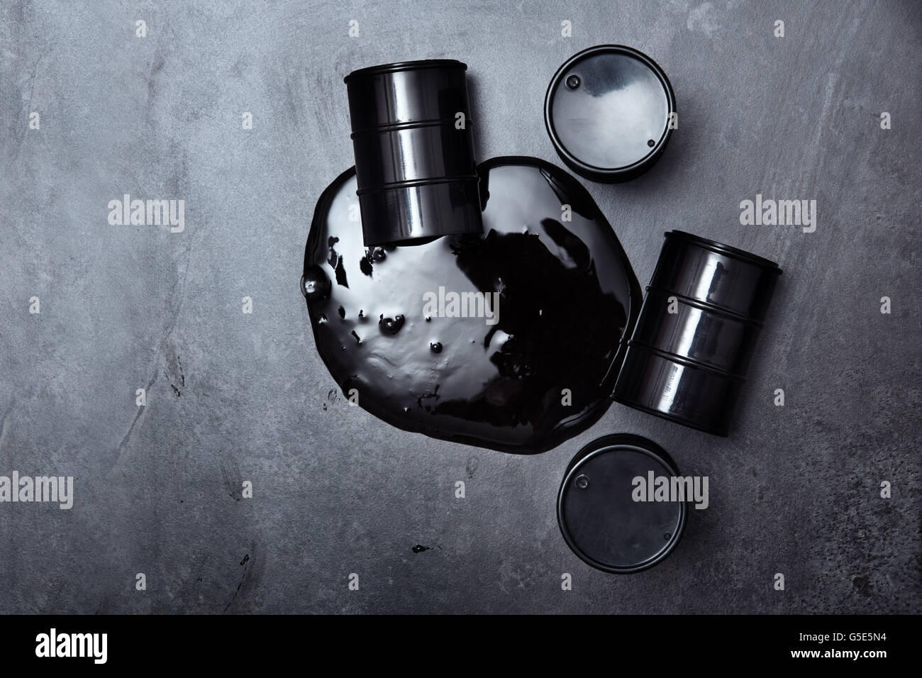 Containers with oil spilled at industrial site Stock Photo - Alamy