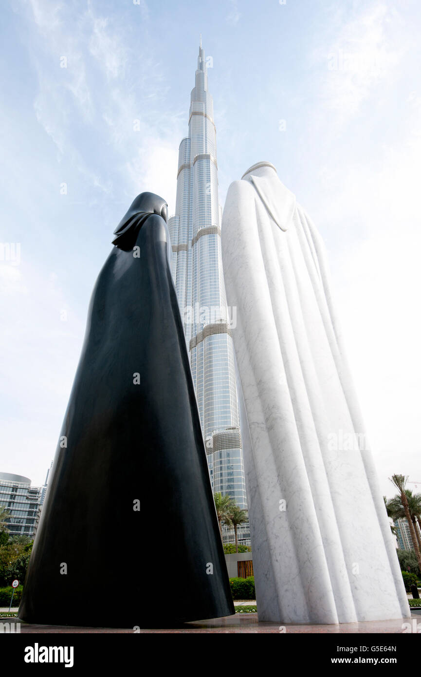 Sculpture of an Arab man and an Arab woman in front of the Burj Khalifa ...