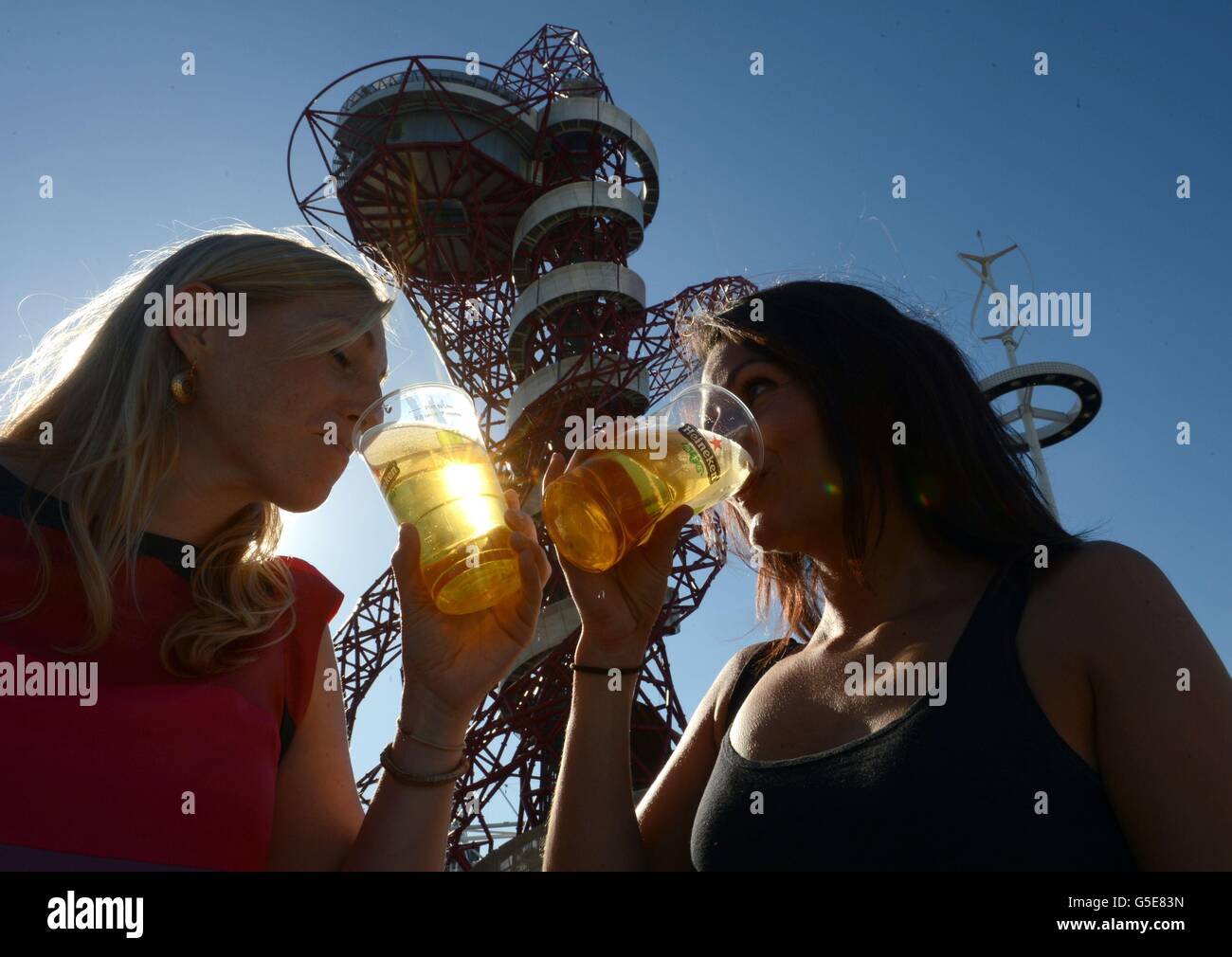 Rachel Bender and Petra Urbanova enjoy a beer in front of the Orbit as ...