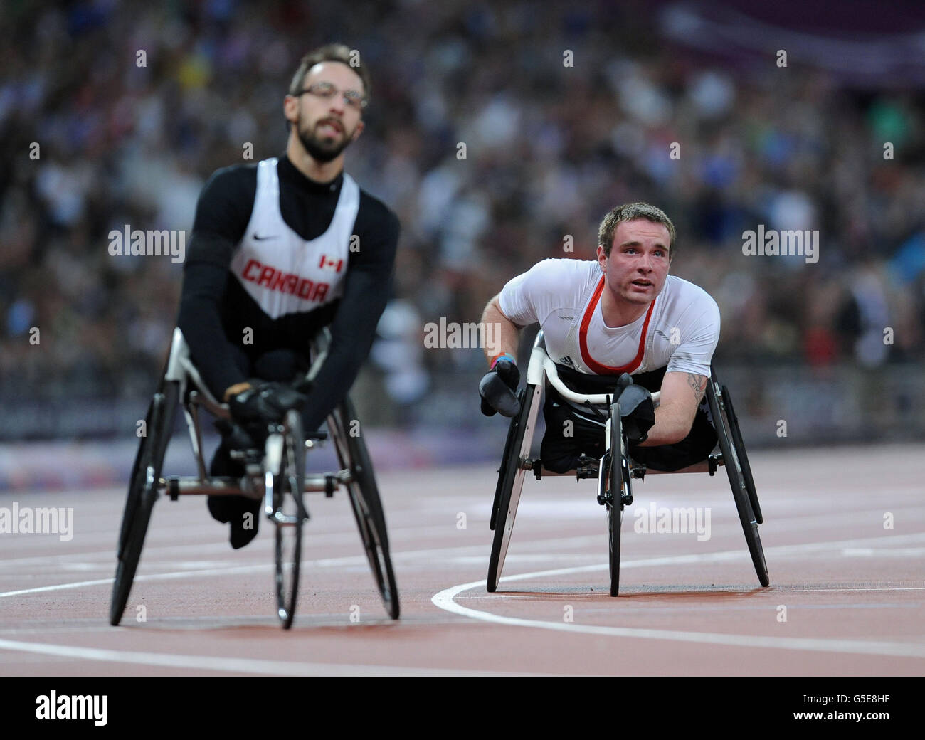 Great Britain's Mickey Bushell (right) reacts after he crosses the line ...
