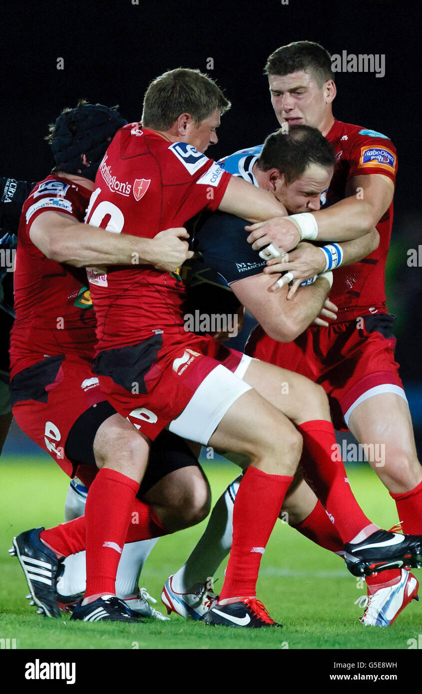 Glasgow's Graeme Morrison is tackled by Scarlets' Rhys Priestland ...