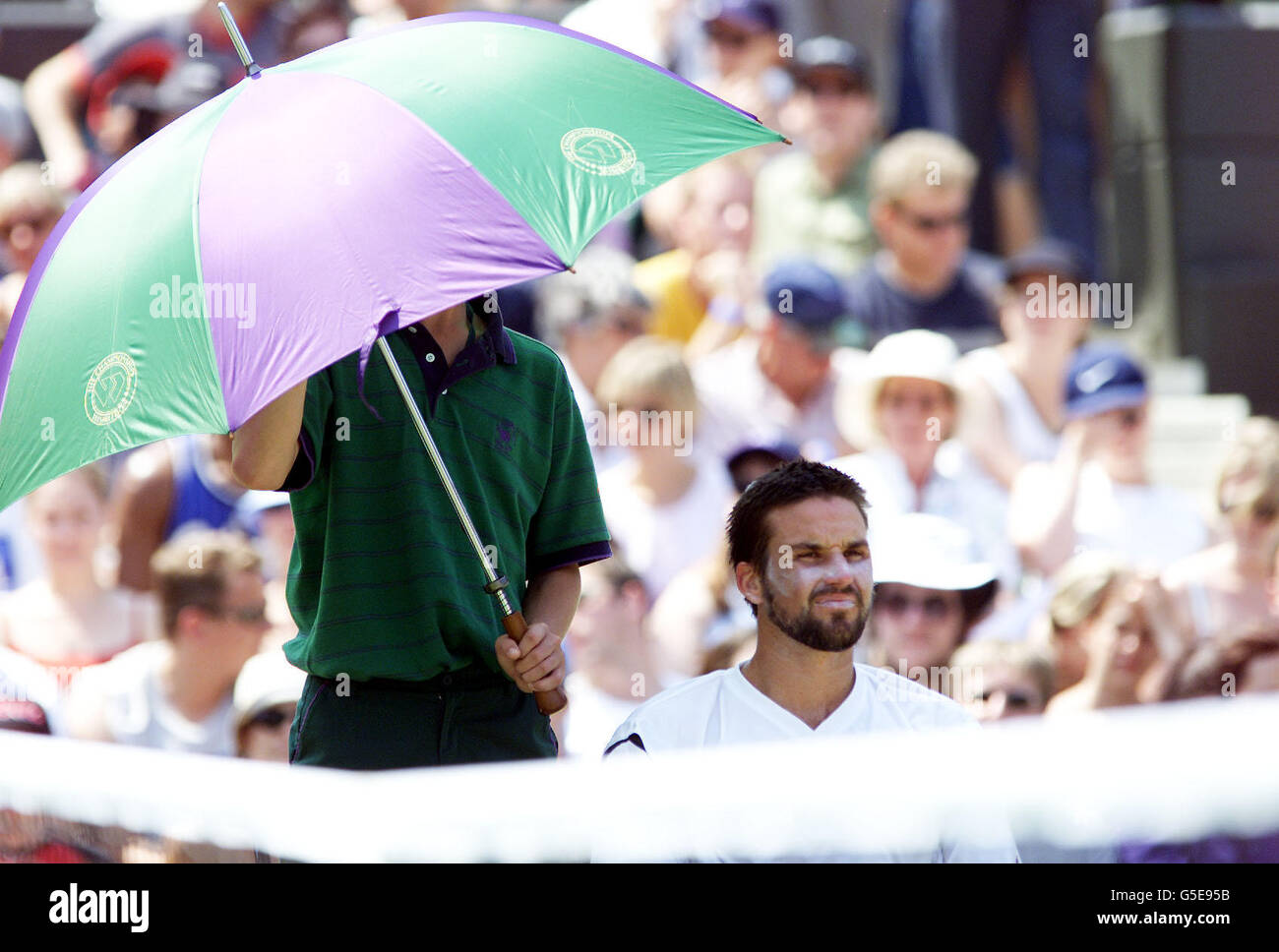 NO COMMERCIAL USE: Pat Rafter of Australia is sheletered from the sun ...