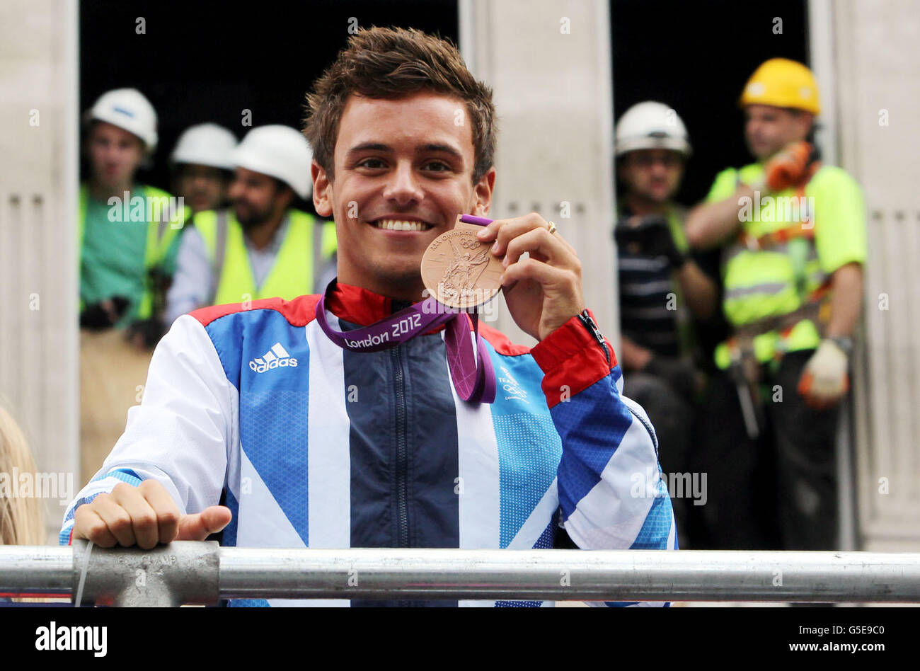 Diver Tom Daley shows off his medal as the parade celebrating Britain's ...