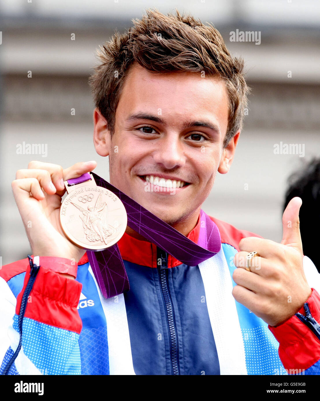 Great Britain's Tom Daley shows his bronze medal to the crowd as the ...