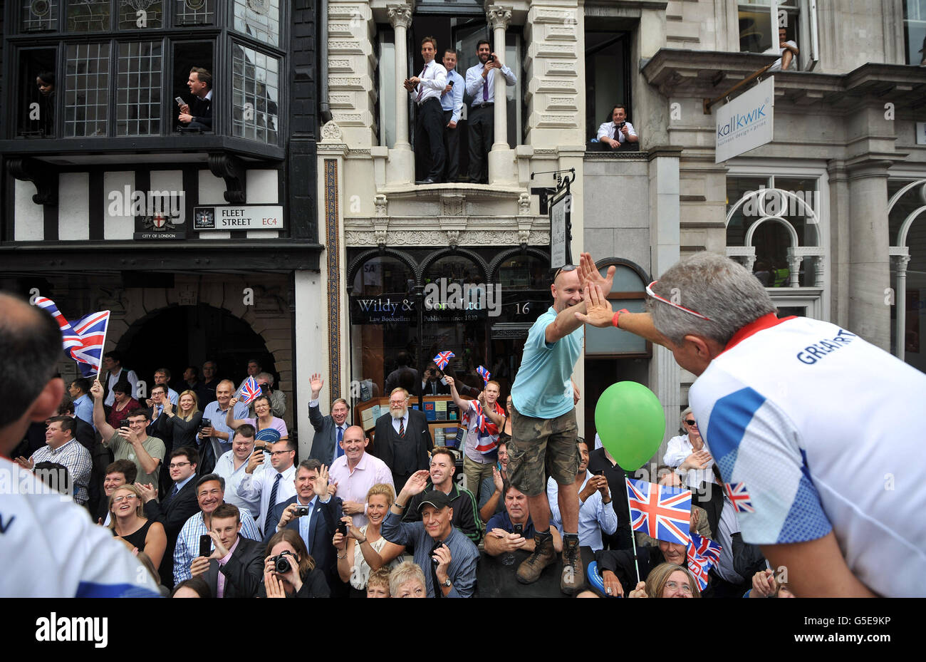 The crowd wave as the parade makes its way through London, celebrating ...