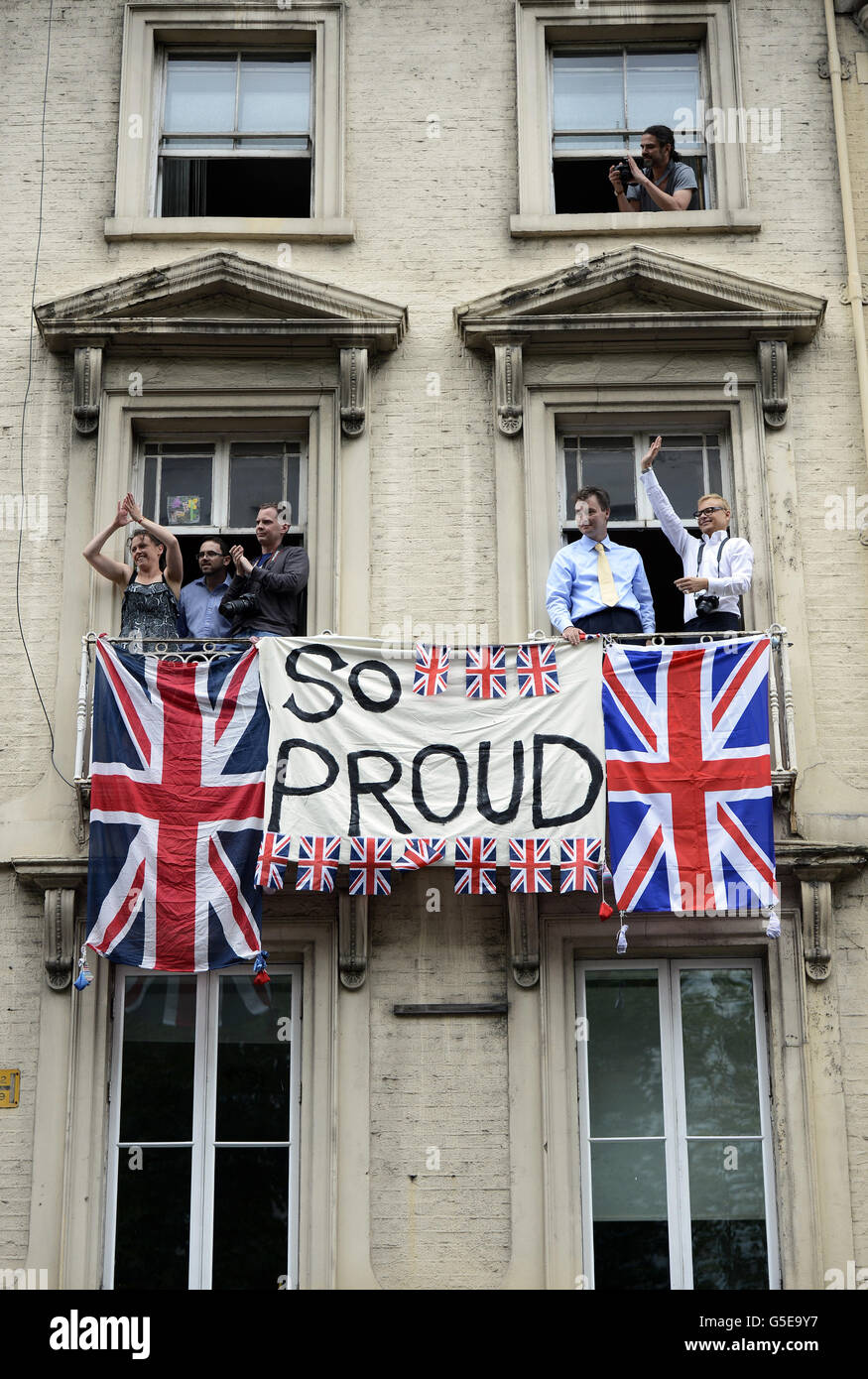 Crowds cheer from windows along the route of the parade through London ...