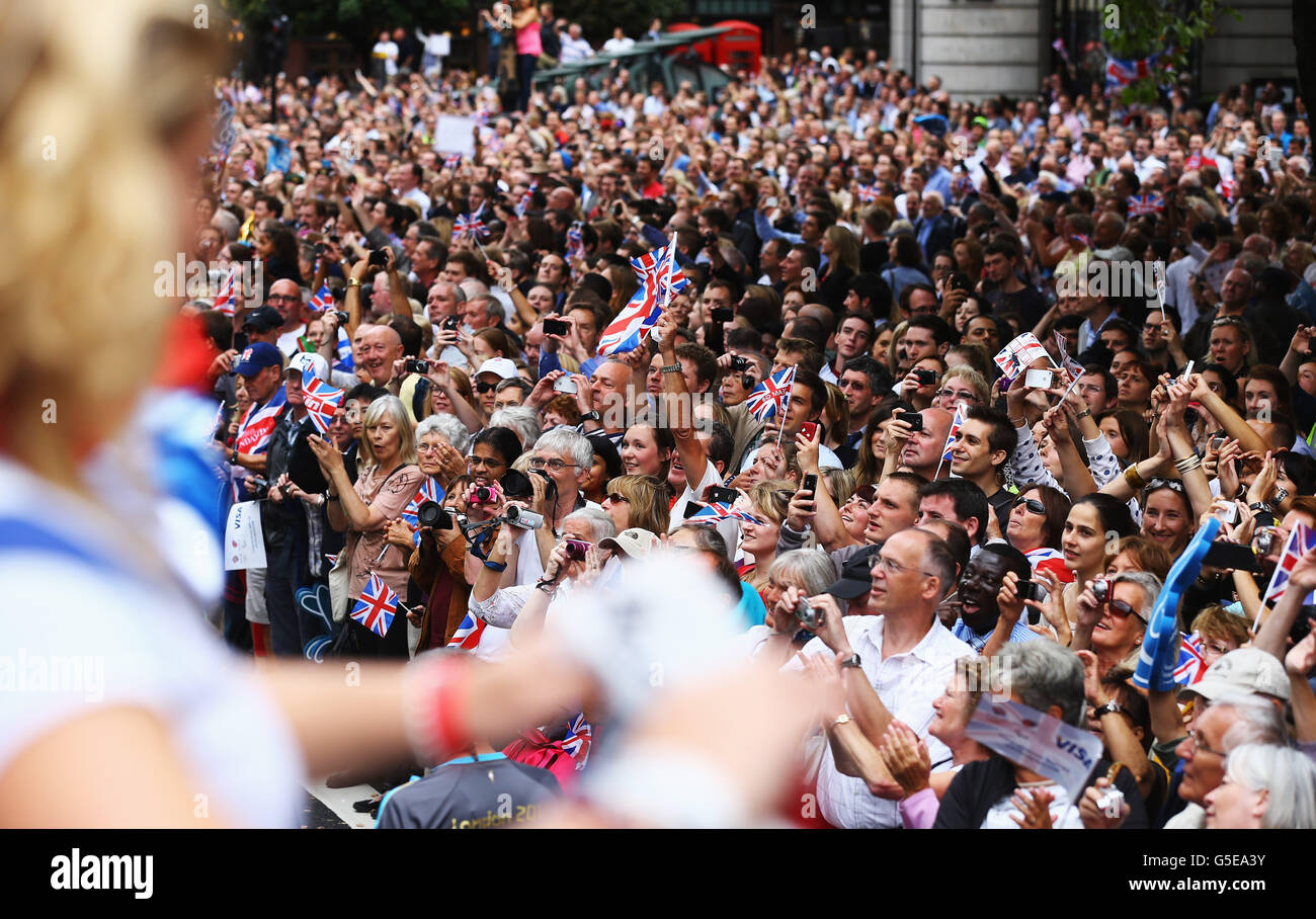Members of the public cheer on the athletes as they take part in the ...