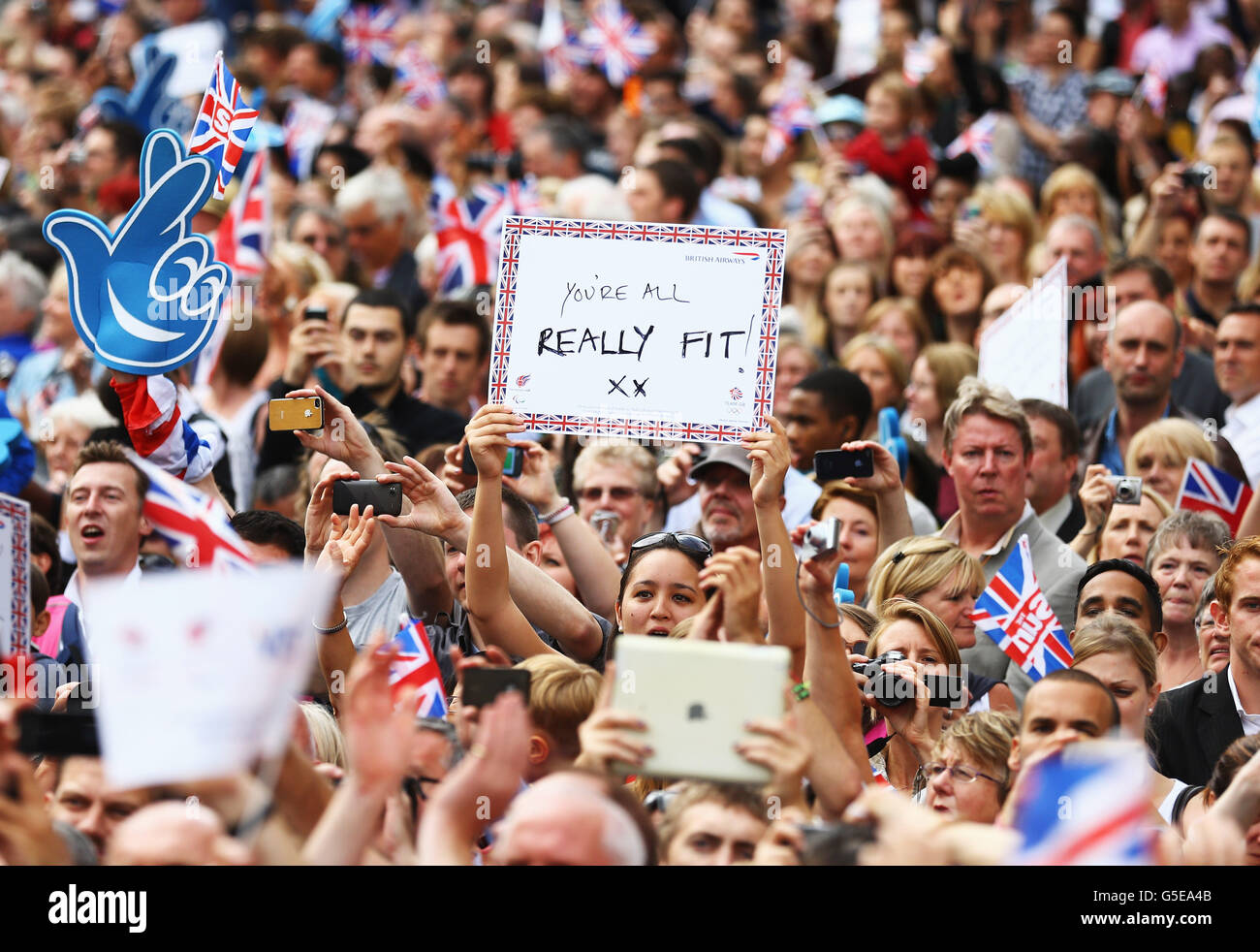 Members of the public cheer on the athletes as they take part in the ...