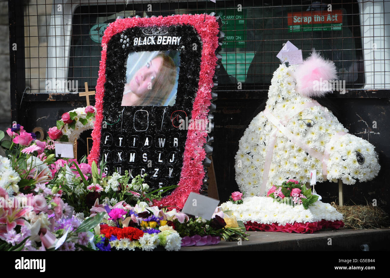 Floral tributes on a truck arrives at North East Surrey Crematorium, in ...