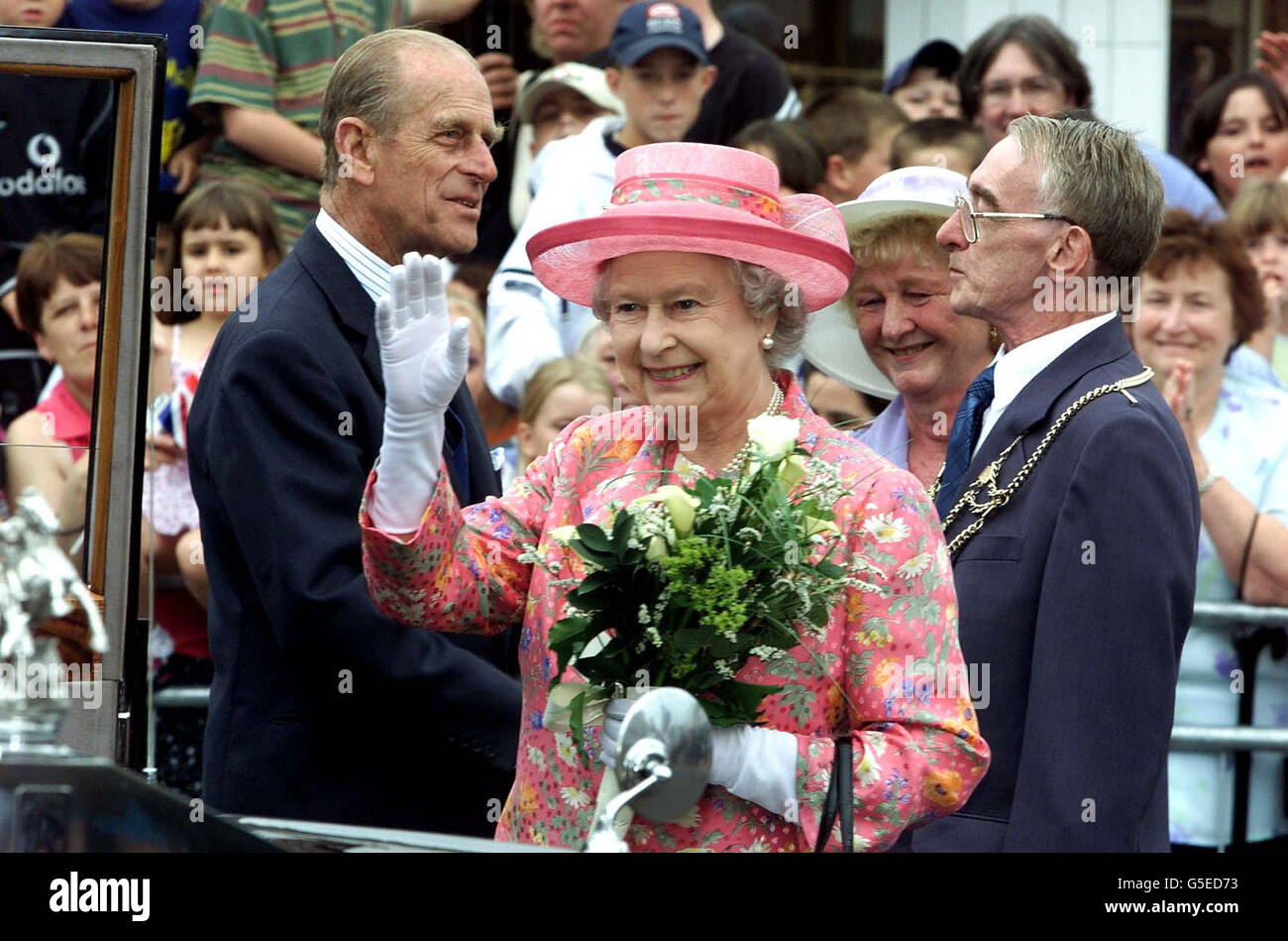 Britain's Queen Elizabeth II waves to the crowd during a walkabout with ...