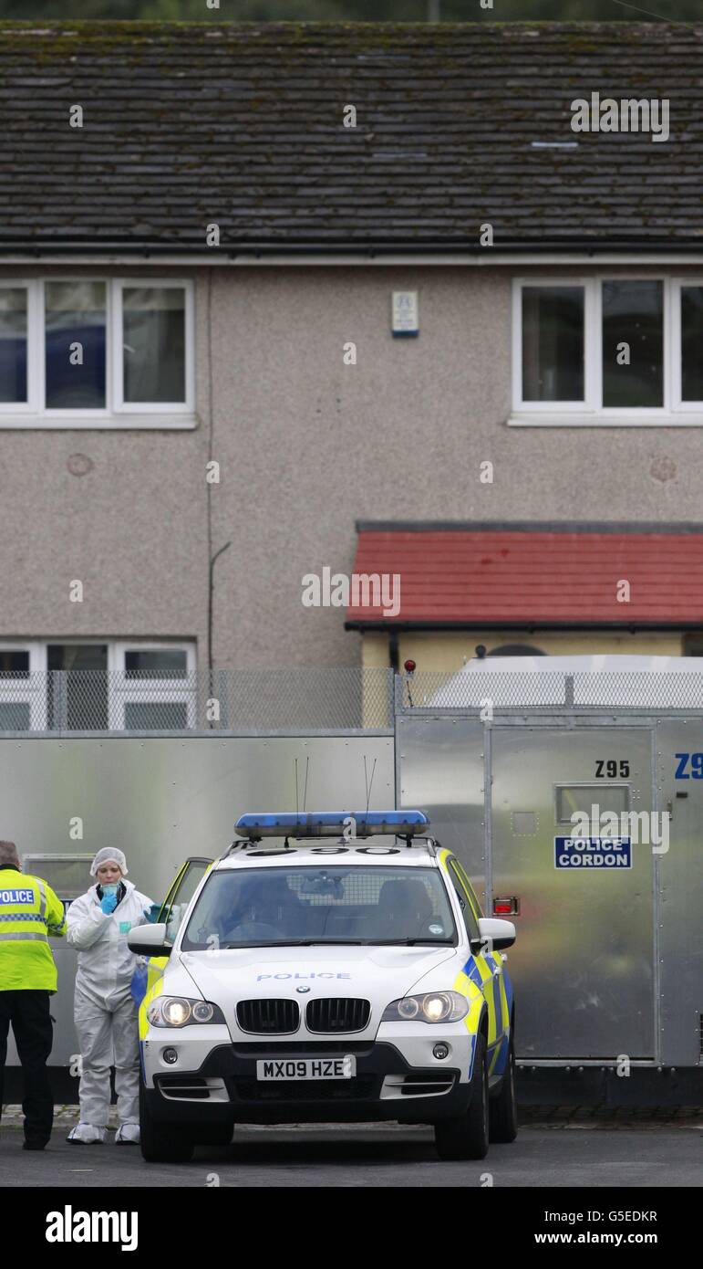 Police forensic officers continue to work at the scene of the shooting ...