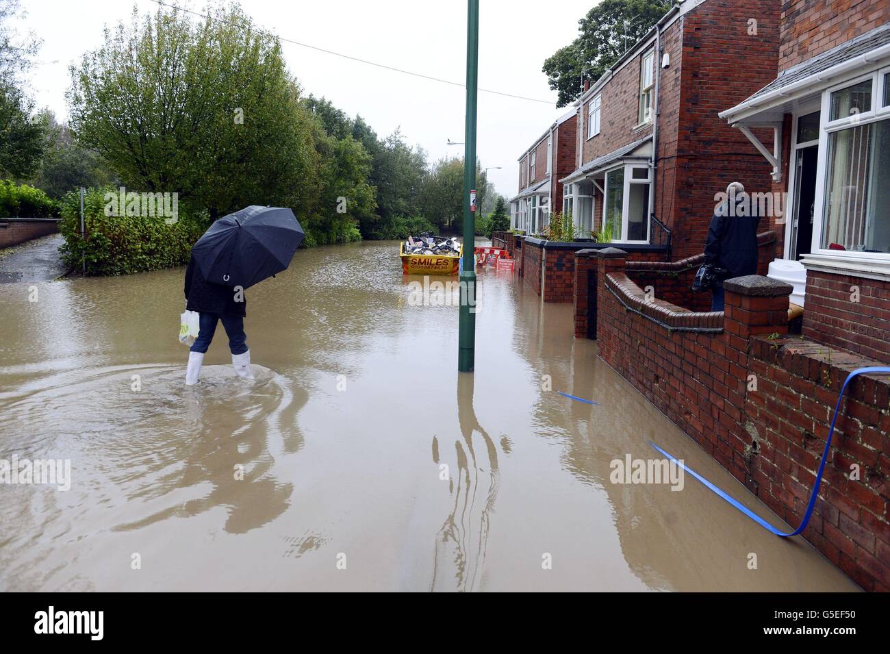 Residents make their way through flood water in Chester-Le-Street, as ...