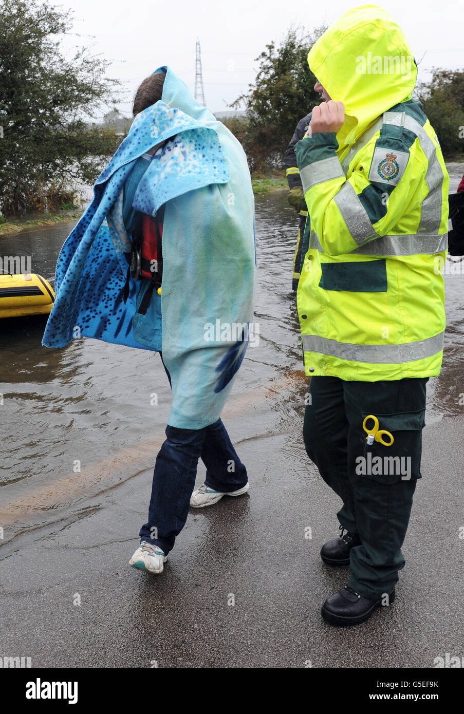 A stranded motorist is helped by a member of the emergency services ...