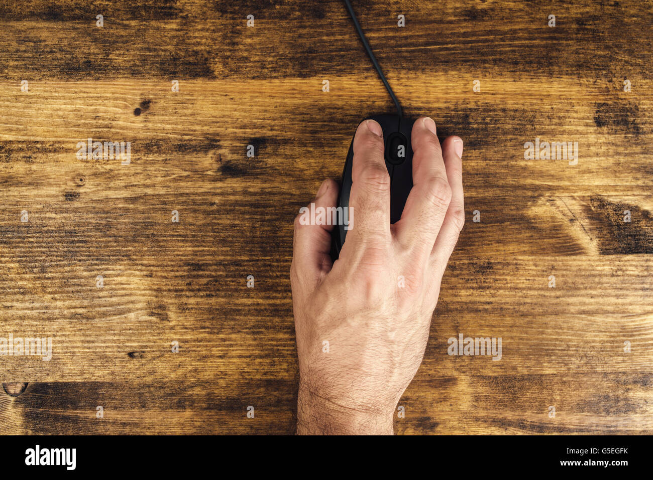 Man using computer mouse, top view of male hand and pointing device on ...
