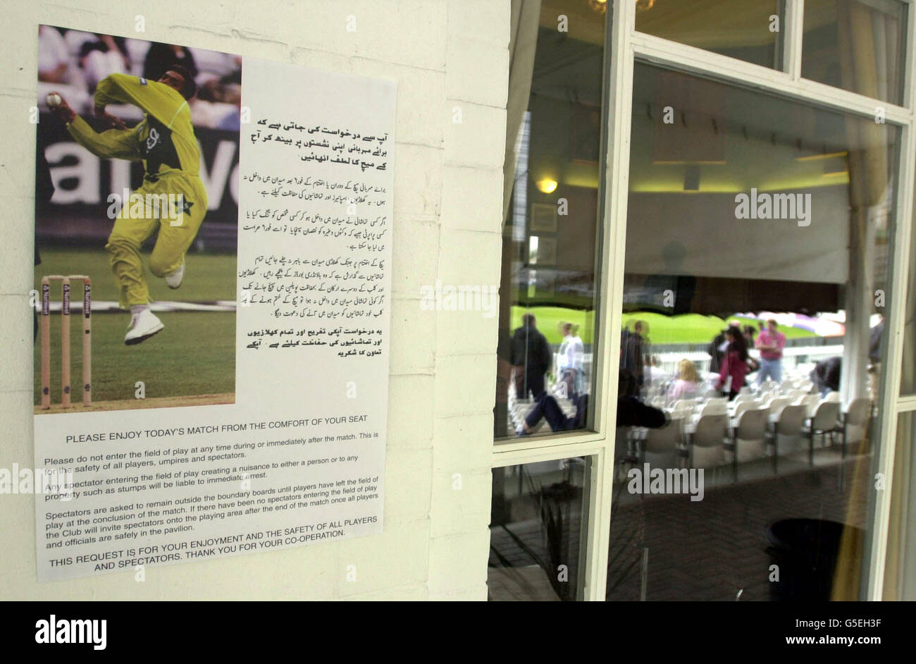 A poster in English and Urdu, advising against a pitch invasion at ...