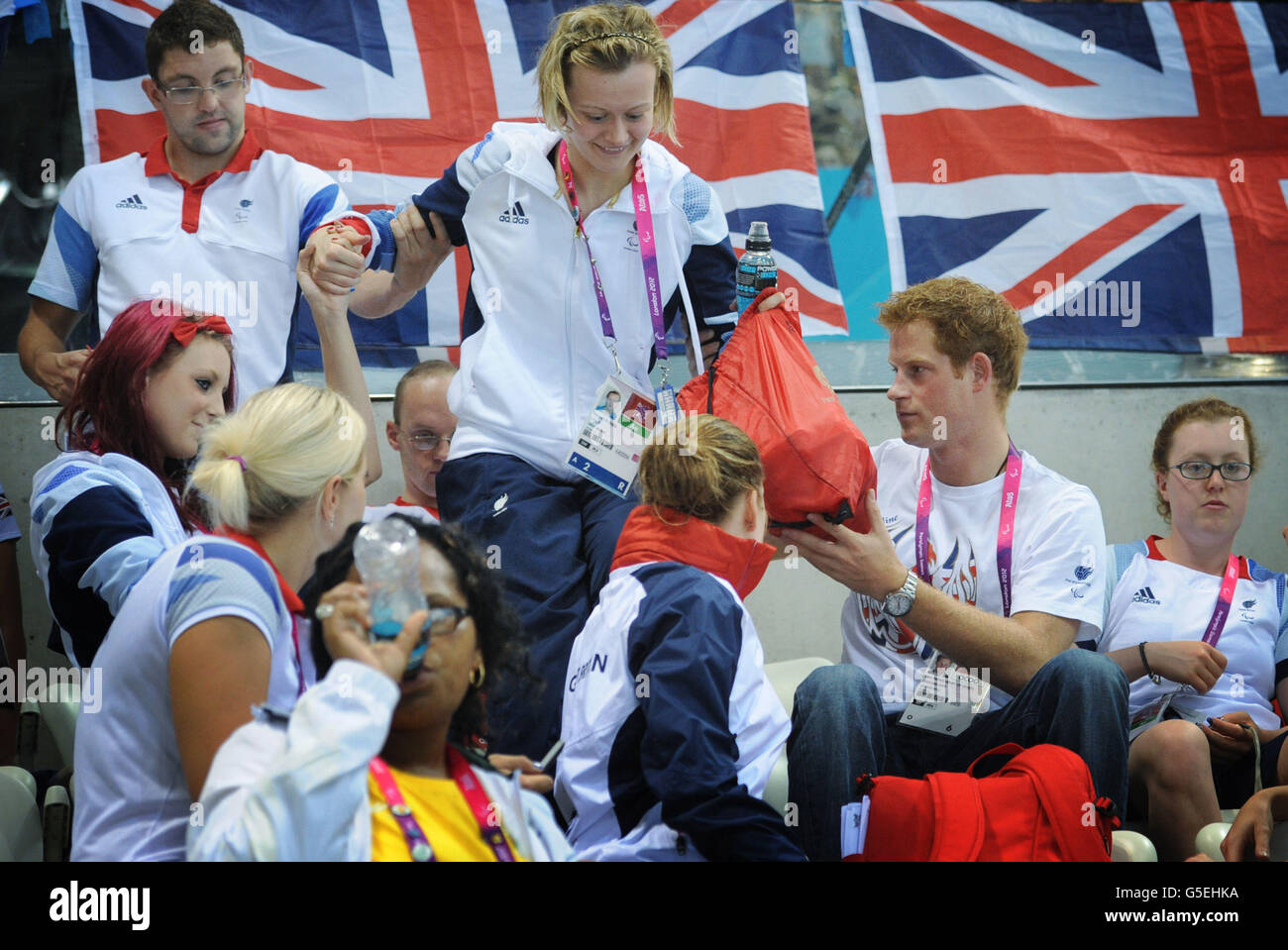 Prince Harry helps Team GB swimmer Hannah Russell to her seat when he ...