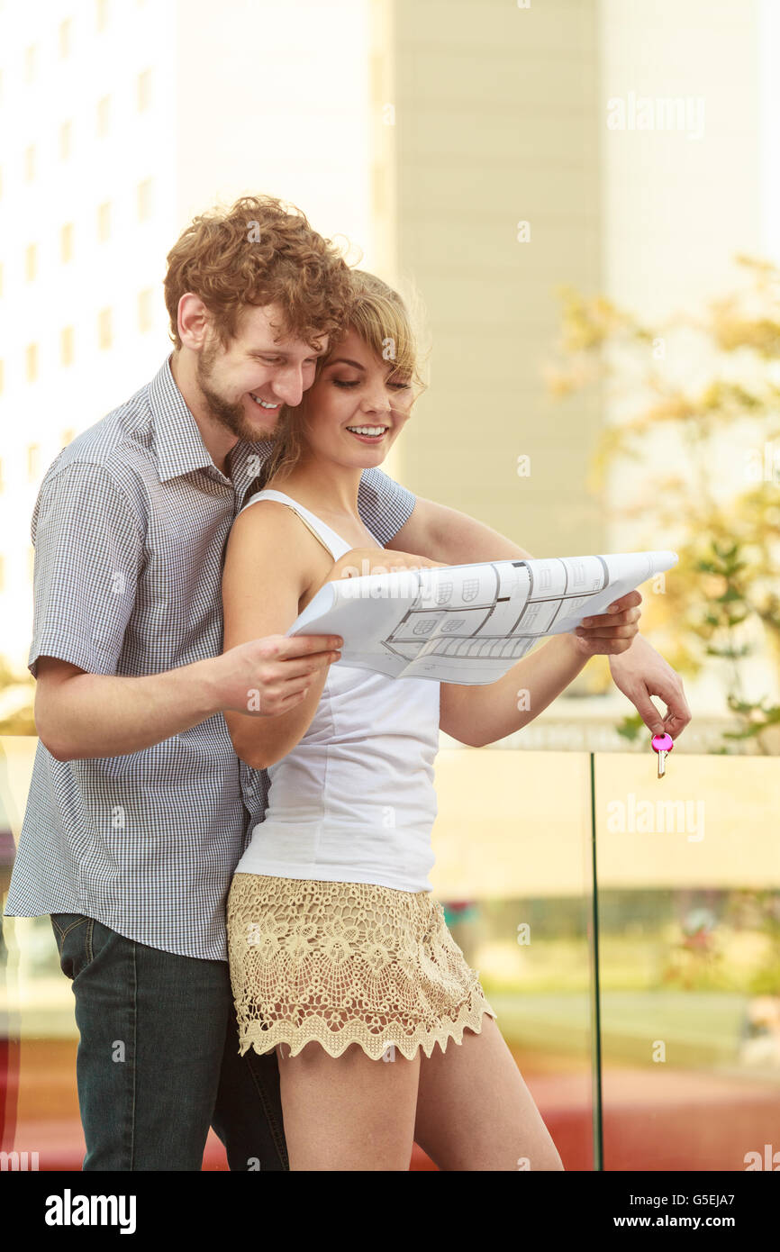 Real estate and family concept - young couple with blueprint project ...