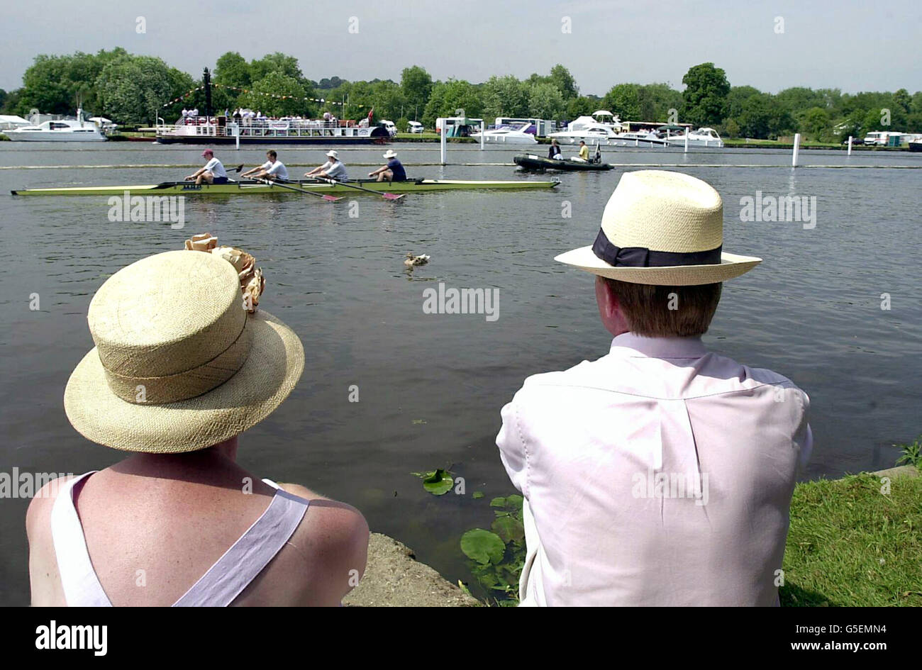 A couple watch the rowing at Henley Royal Regatta at Henley on the ...