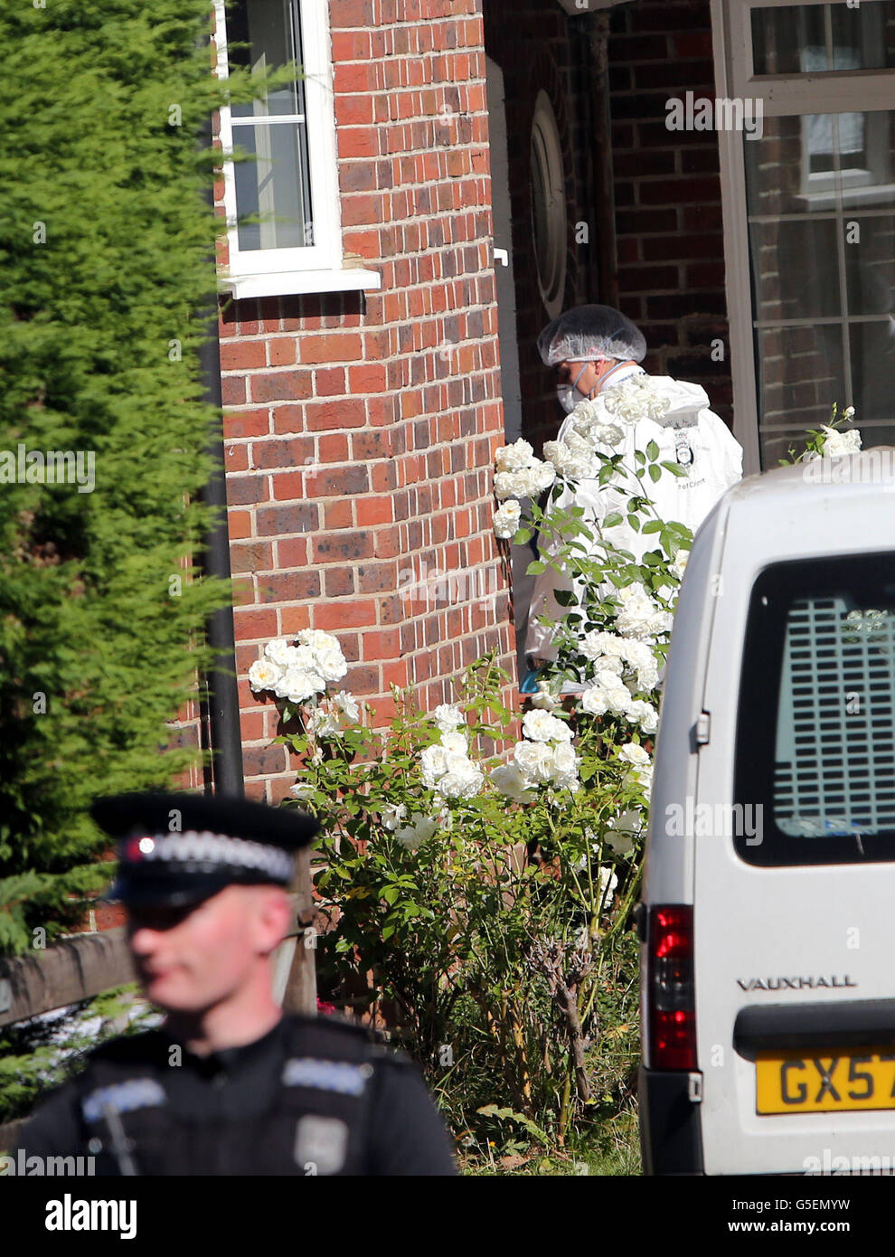A British Scenes of Crime Officer (SOCO) outside the home of French ...