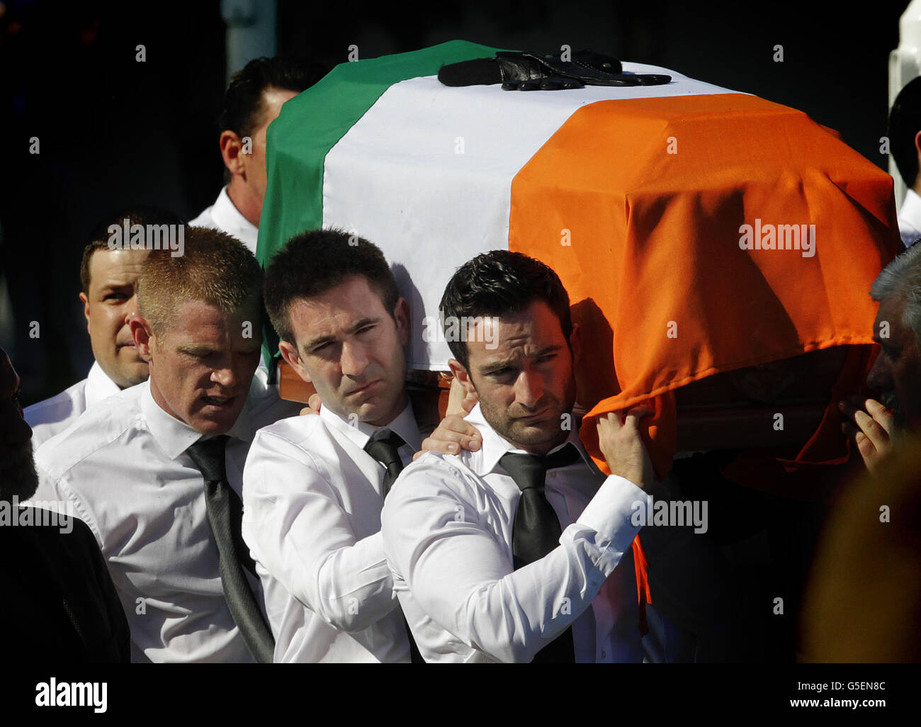 Mourners carry the coffin of Real IRA member Alan Ryan into the Church ...