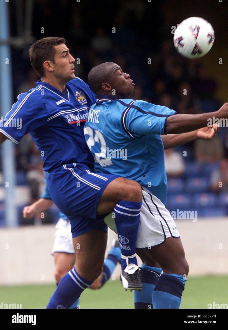 Manchester City's Leon Mike (right) is tackled by Halifax Town's Andrew ...