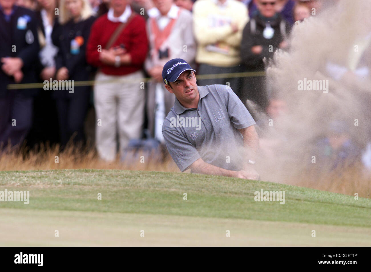 Ireland's Paul McGinley comes out of the bunker onto the first green ...