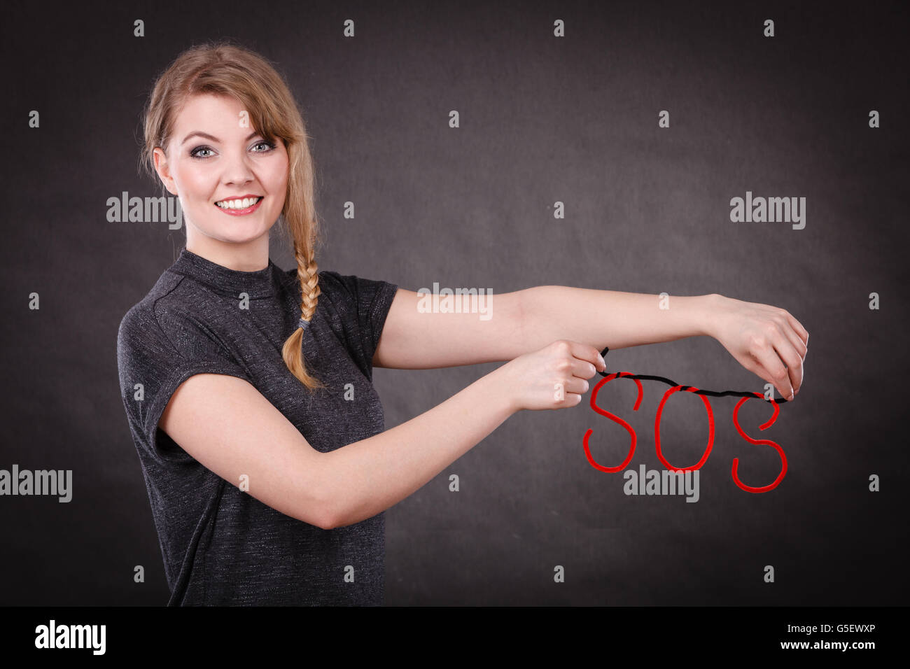 Help concept. Young blonde smiling woman with red sos symbol sign ...