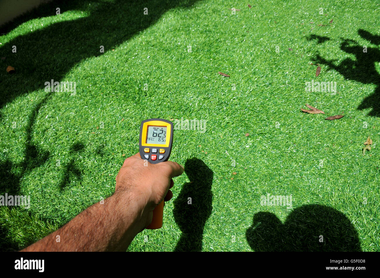 Measuring the temperature of artificial lawn in direct sun - 62 degrees ...