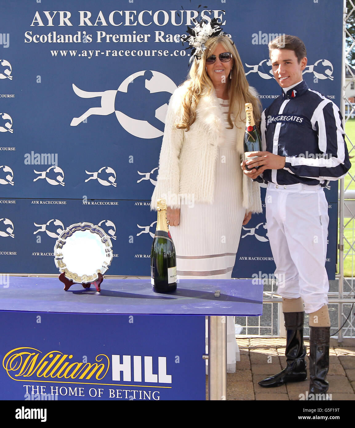 Jockey Michael Metcalfe is presented with champagne after riding Hay ...