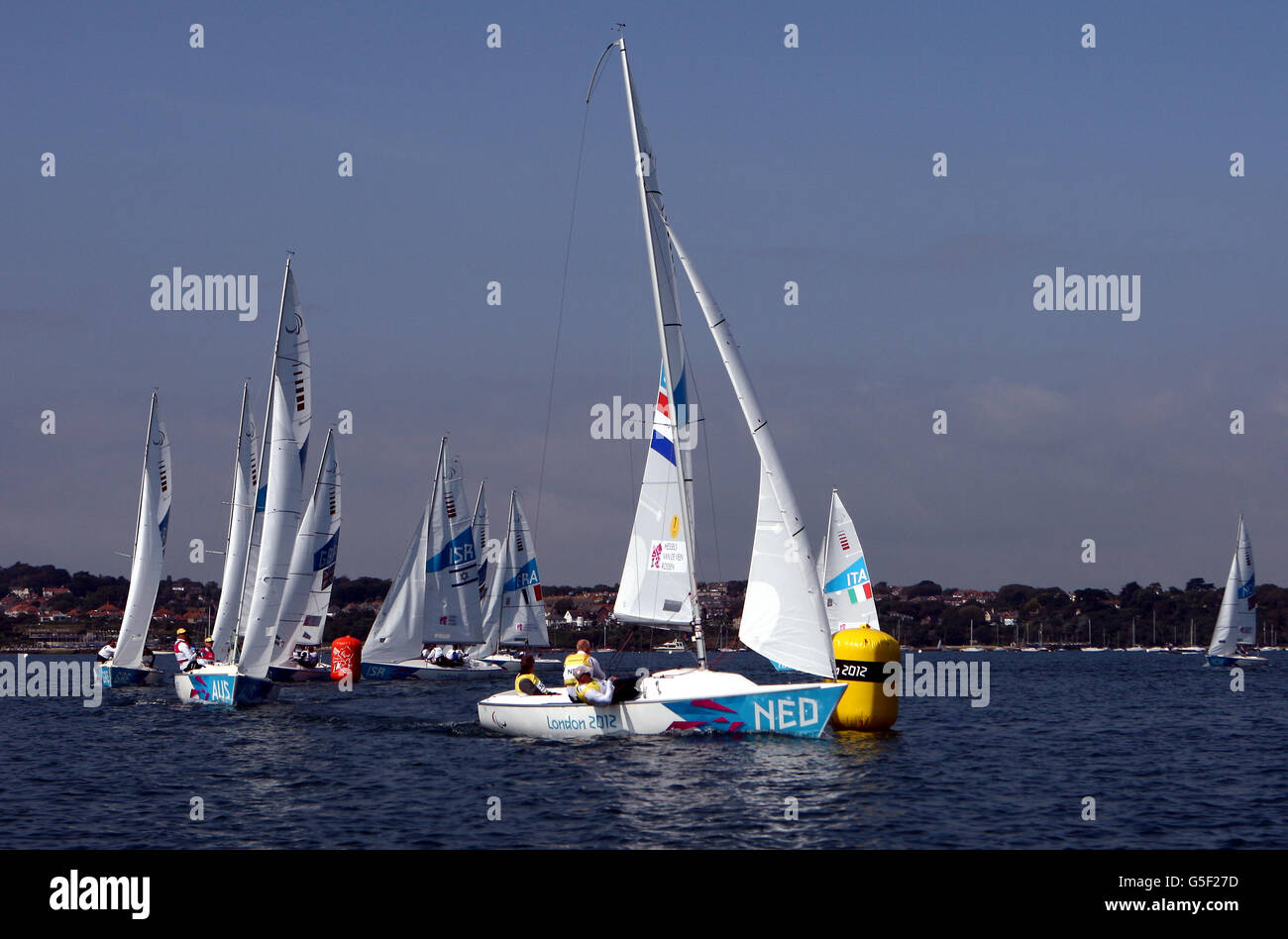 Netherlands crew lead the Sonar fleet around the windward mark during ...