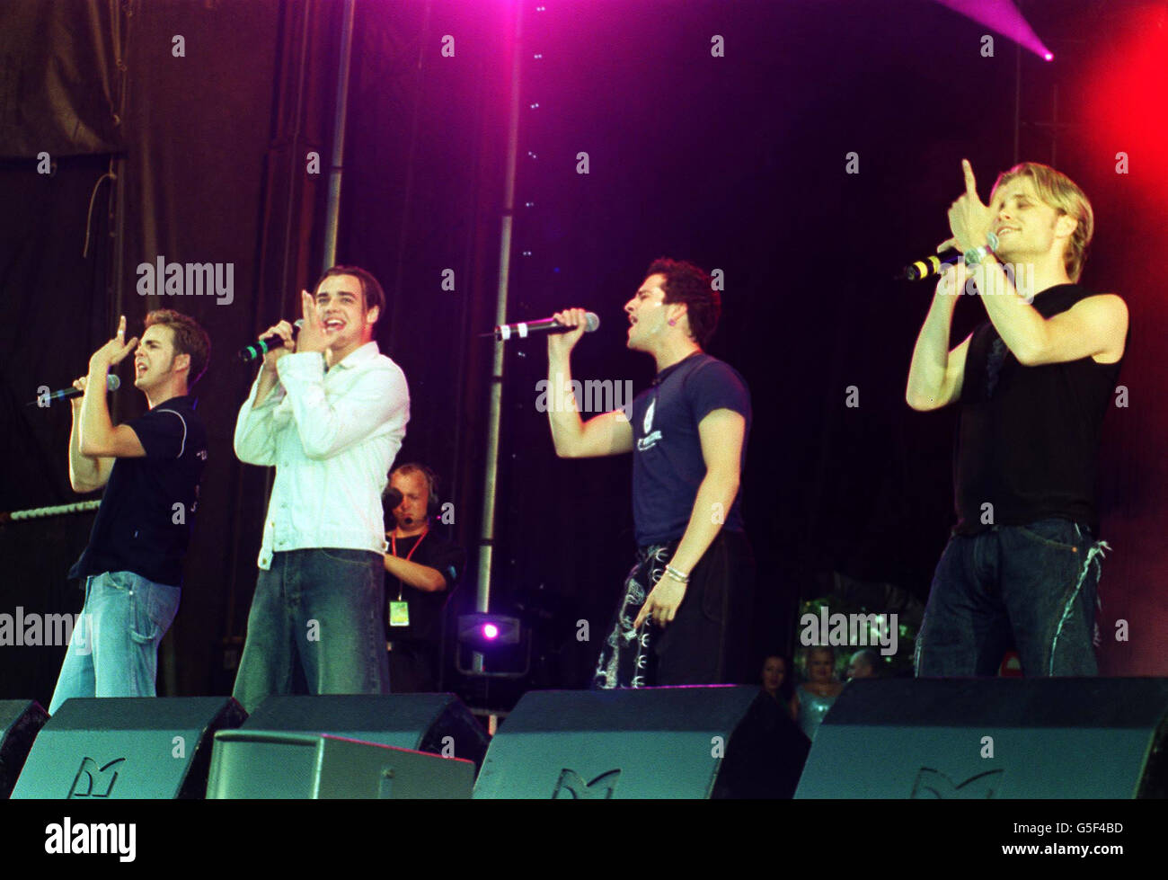 Celebrity music singing on stage microphone boy band hi-res stock ...