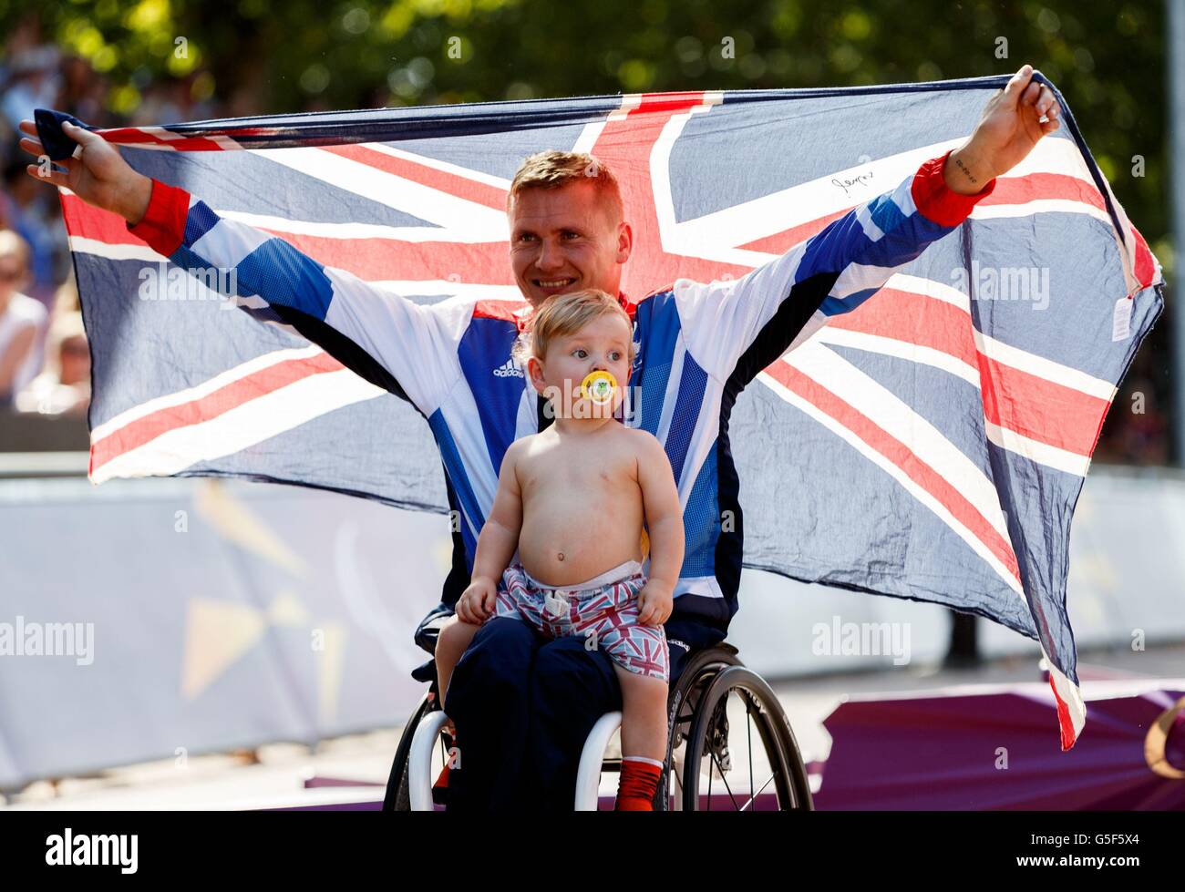 Great Britain's David Weir celebrates his gold with medal with his son ...