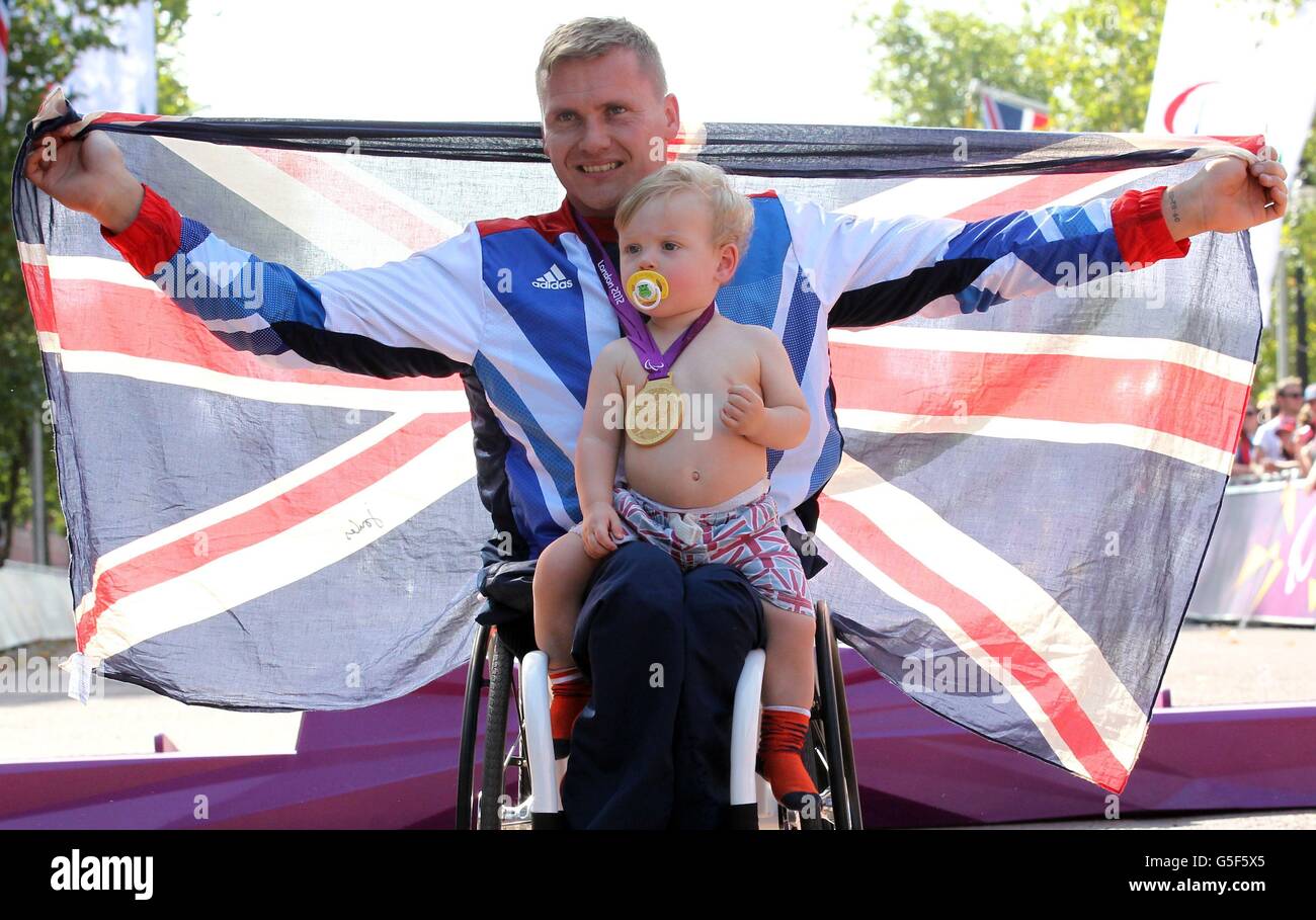 Great Britain's David Weir celebrates his gold with medal with his son ...