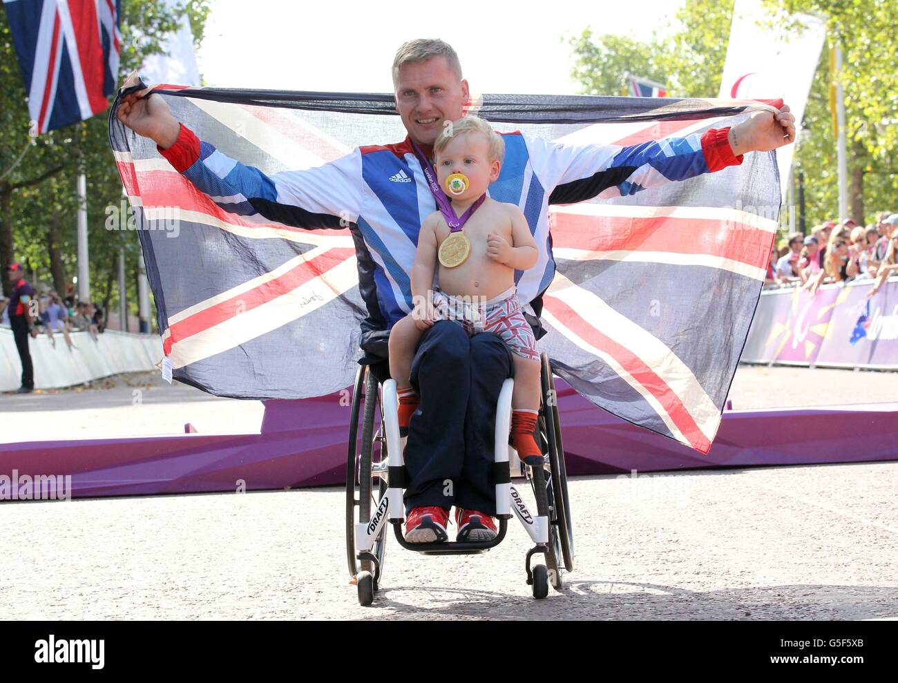 Great Britain's David Weir celebrates his gold with medal with his son ...