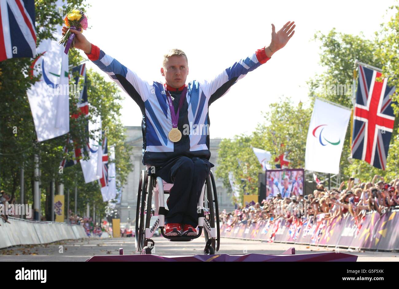 Great Britain's David Weir celebrates his gold with medal with his son ...
