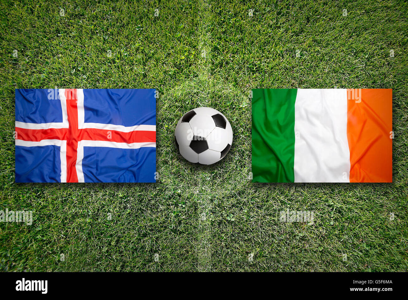 Iceland vs. Ireland flags on green soccer field Stock Photo - Alamy