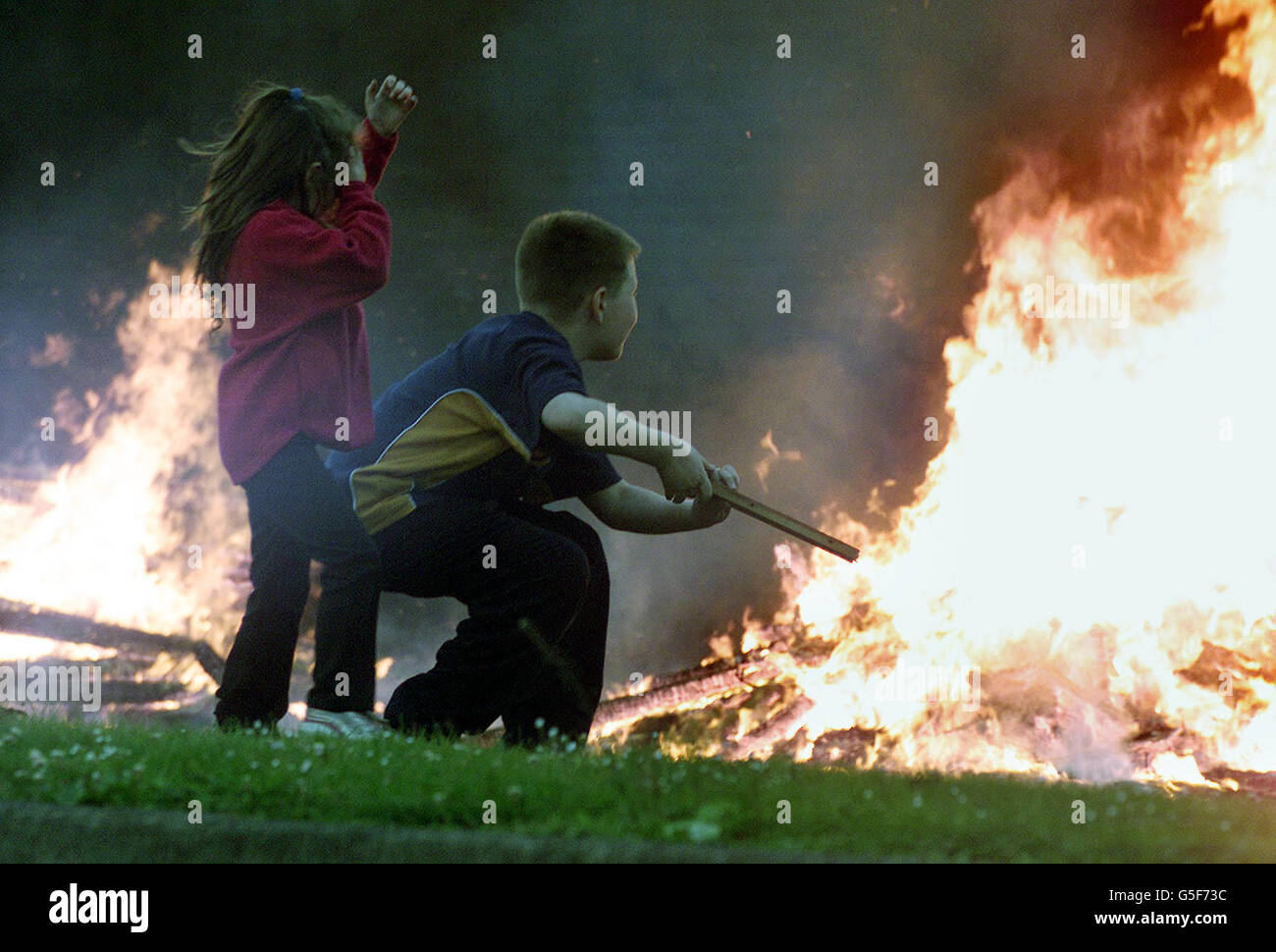 Children play by a 11th night bonfire in the Shankill area of Belfast ...