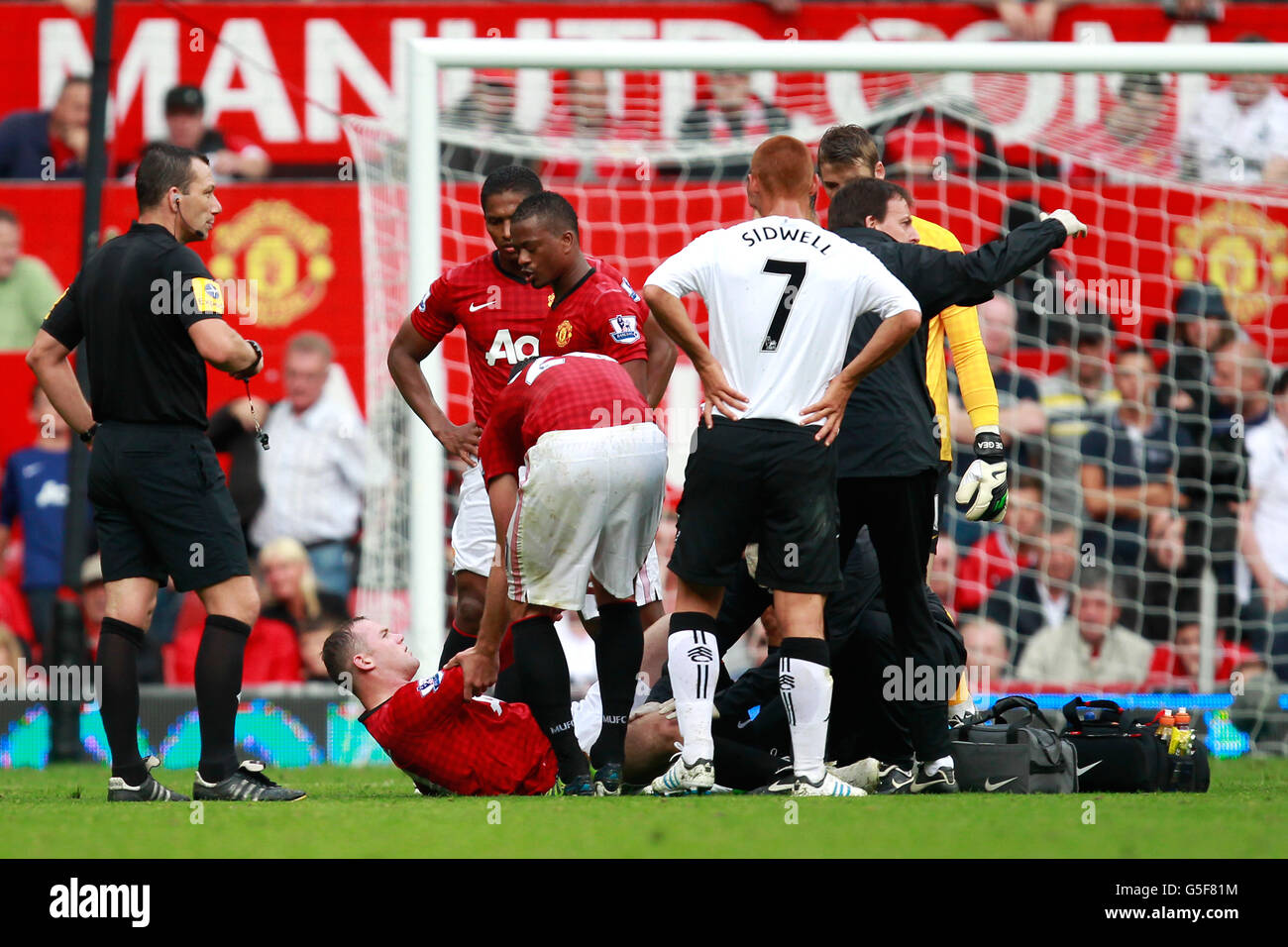 Manchester United's Wayne Rooney receives treatment before being ...